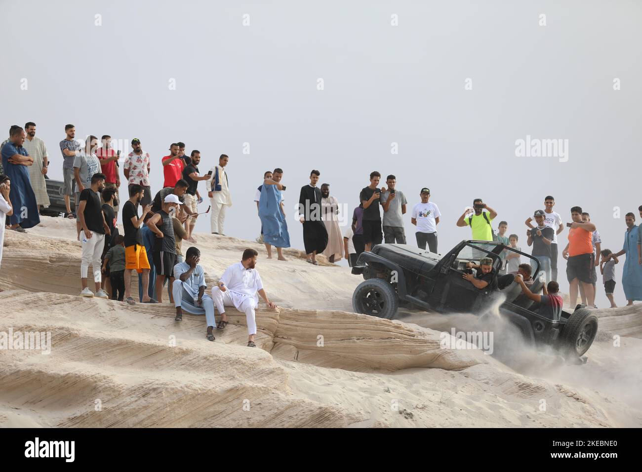Zliten, Libya - 10 Nov 2022, People seen watching a four-wheel drive car climbing the slopes in ...