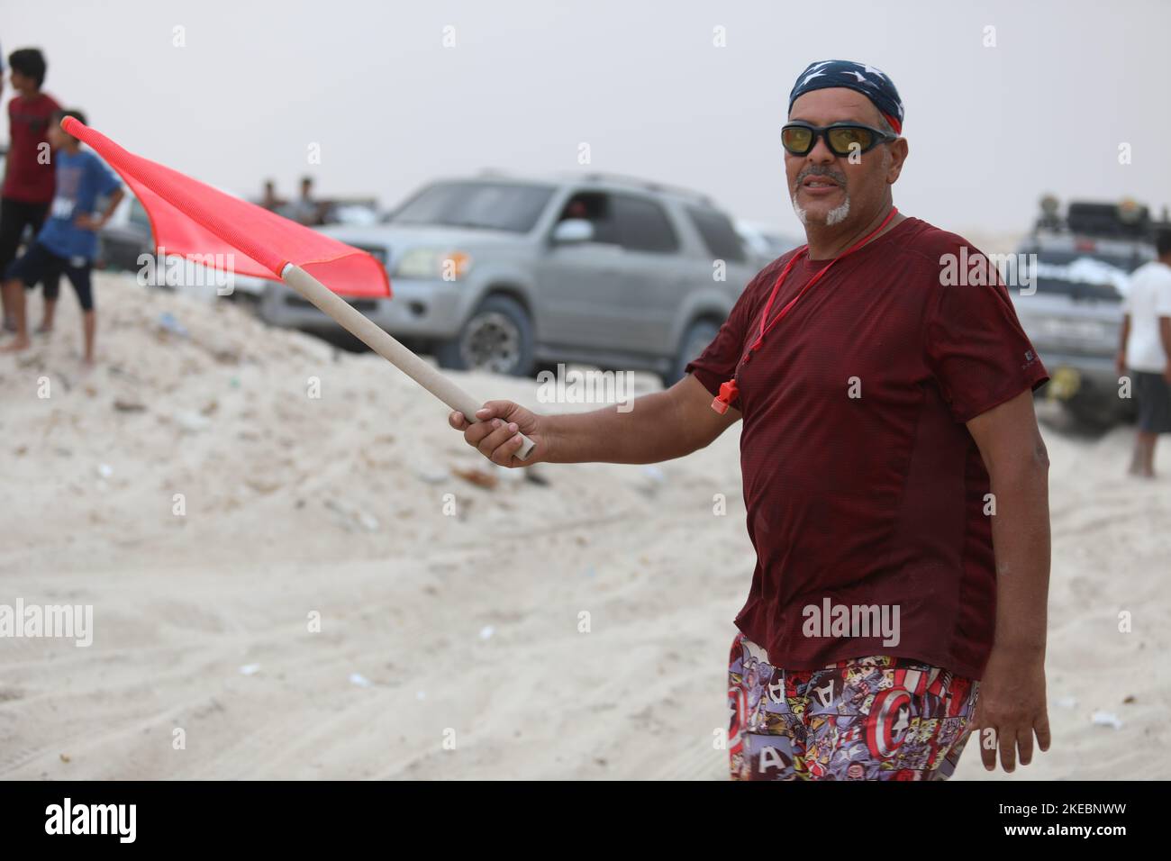 Nuri Elias, a supervisor waves his flag to the competitors to indicate ...