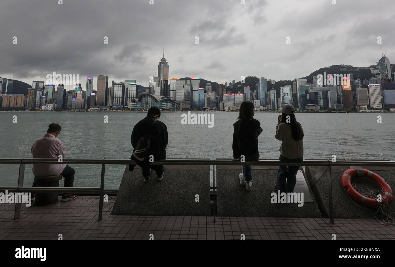 People enjoy the day at the waterfront in Tsim Sha Tsui under typhoon ...