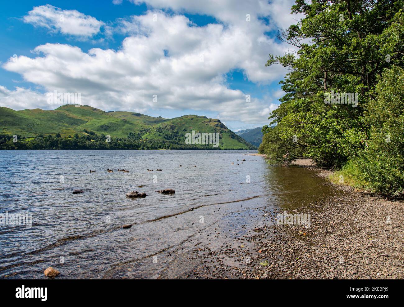 Lakeside view across Ullswater in the Lake District with clouds and ...