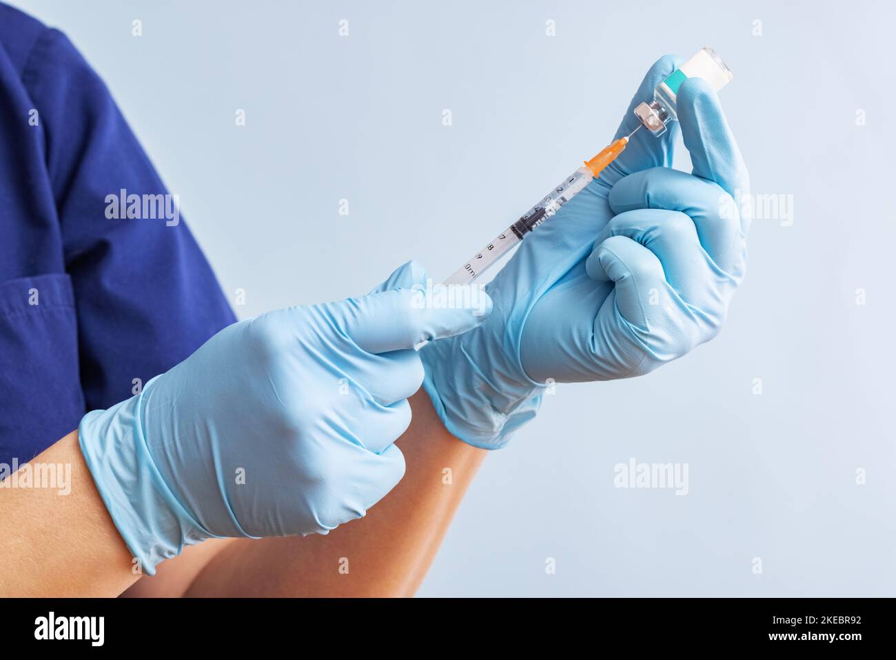 Doctor in blue gloves preparing syringe for injection. Vaccination ...