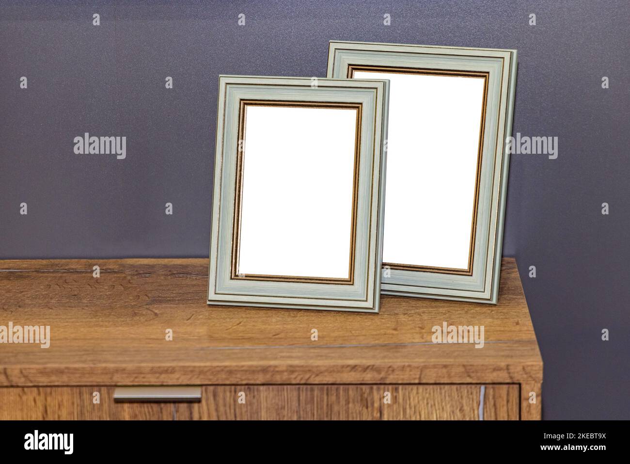 Two Portrait Picture Frames at Wooden Cabinet Stock Photo - Alamy
