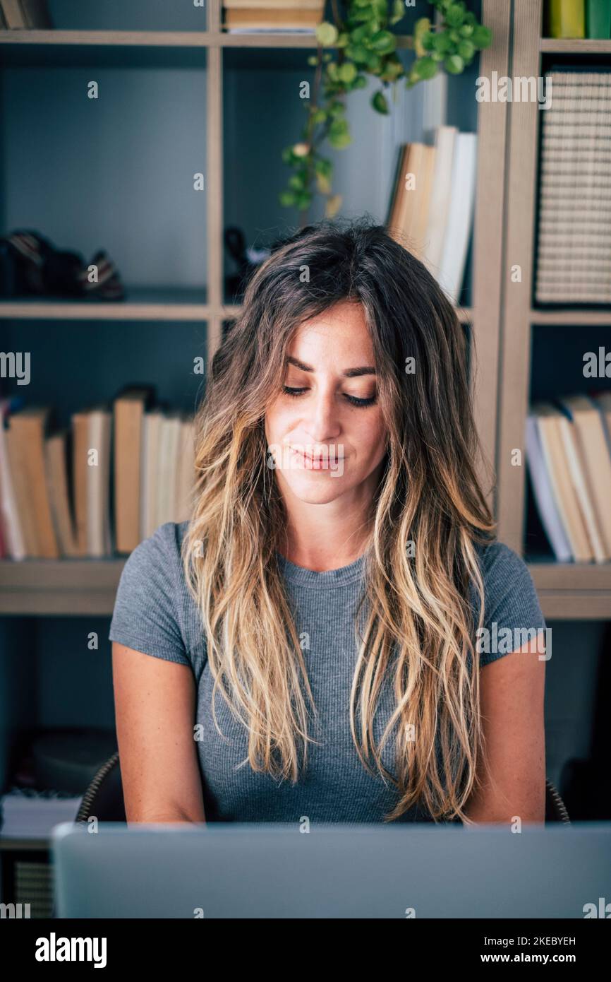 Modern millennial young woman work on computer at the desk in home ...