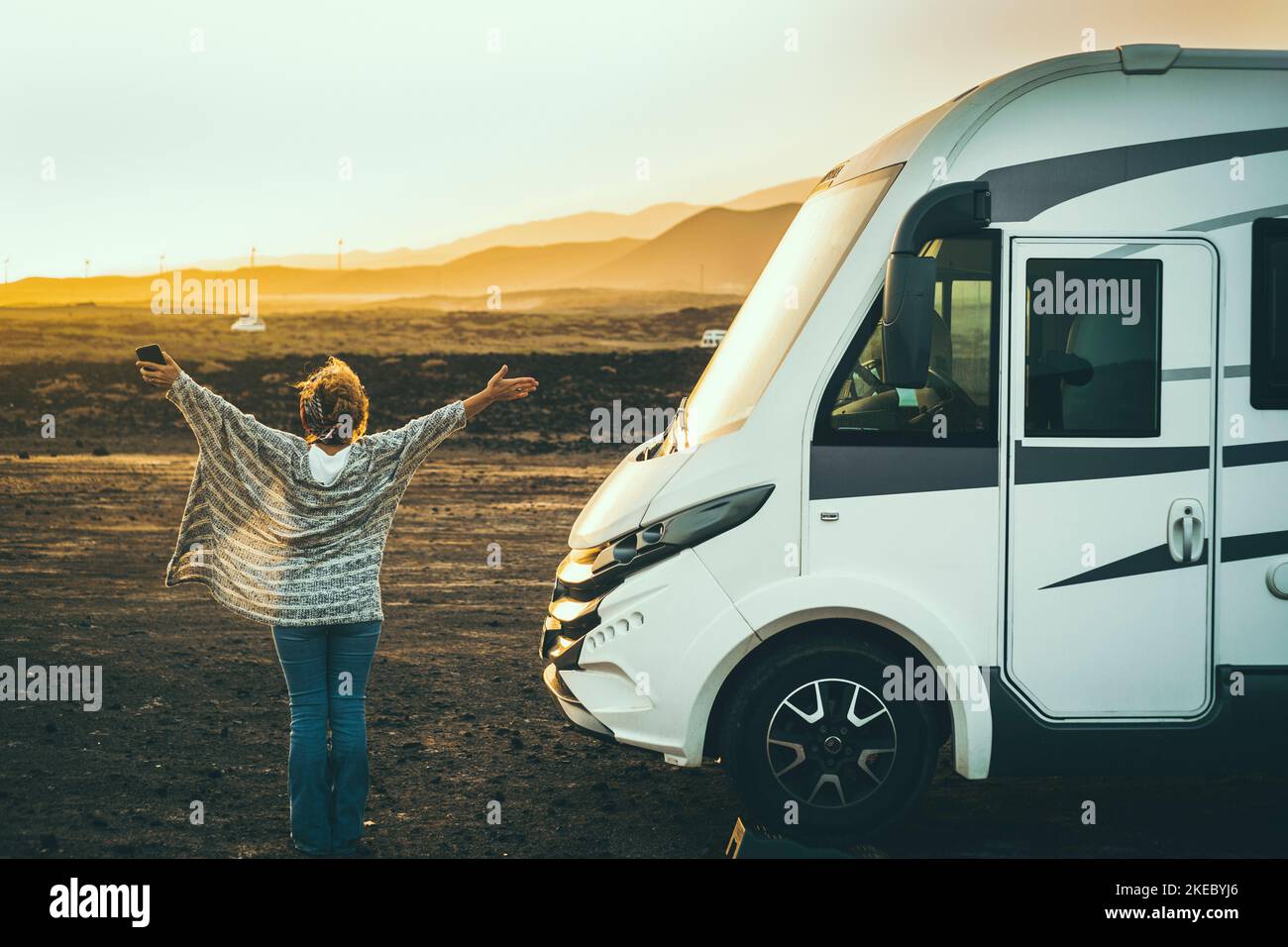 Woman viewed from back enjoy happy her destination in campe van life ...