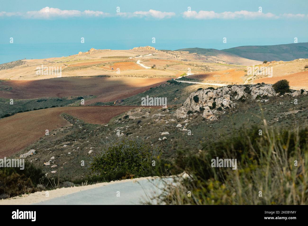 A beautiful landscape scene with brown and orange rocky hills under a ...