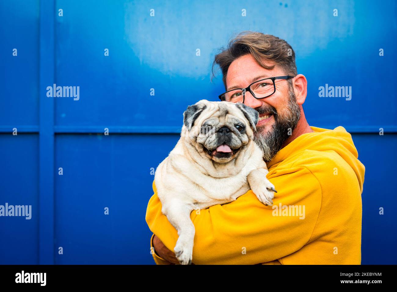 Portrait of man and dog. Young adult handsome with beard and eyewear ...