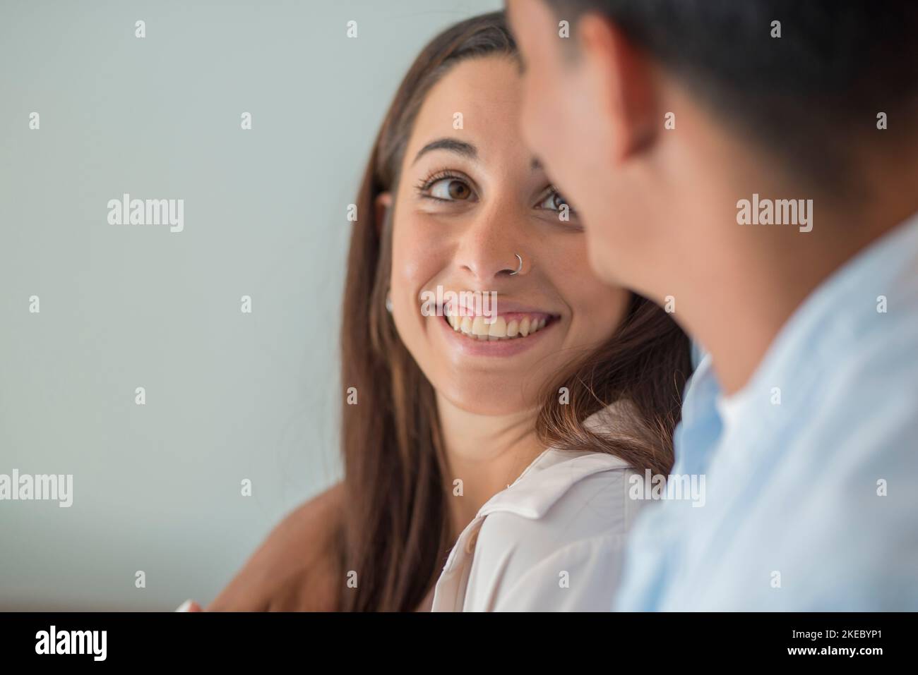 Side portrait view of happy woman smiling and looking her boyfriend ...