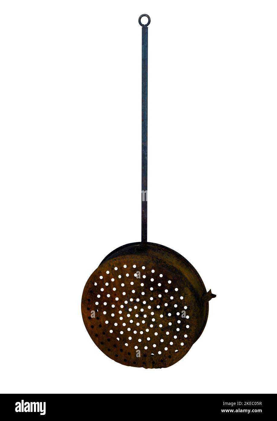 Traditional old roasting pan with holes for cooking chestnuts on wood ...