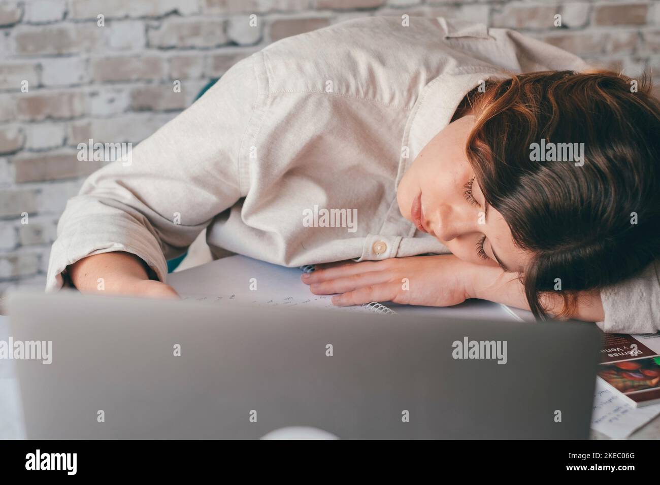 One beautiful female teenager sleeping and resting on the table while ...