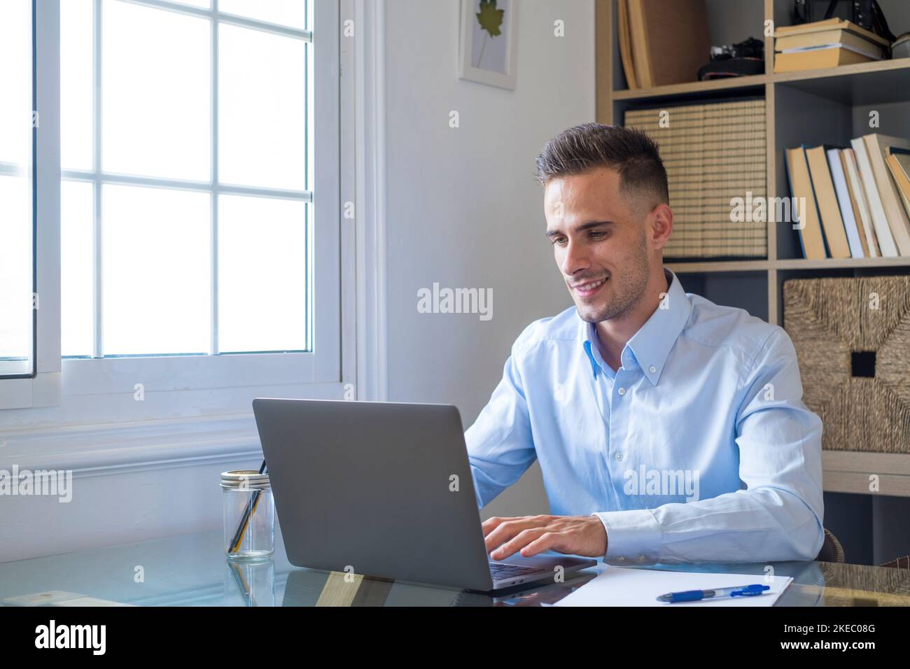 Happy handsome man typing hi-res stock photography and images - Alamy