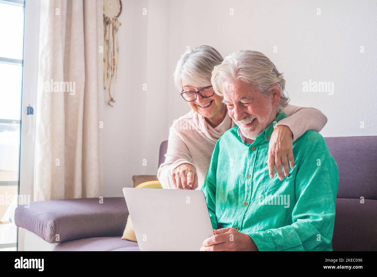 Couple of two old and mature people at home using tablet together in ...