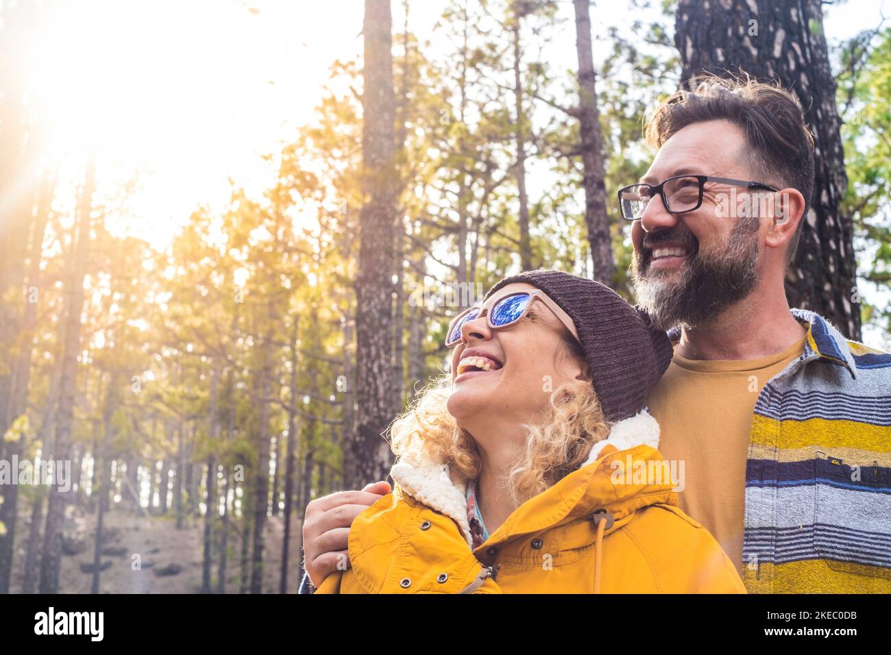portrait of couple of two happy people looking at the trees in the ...