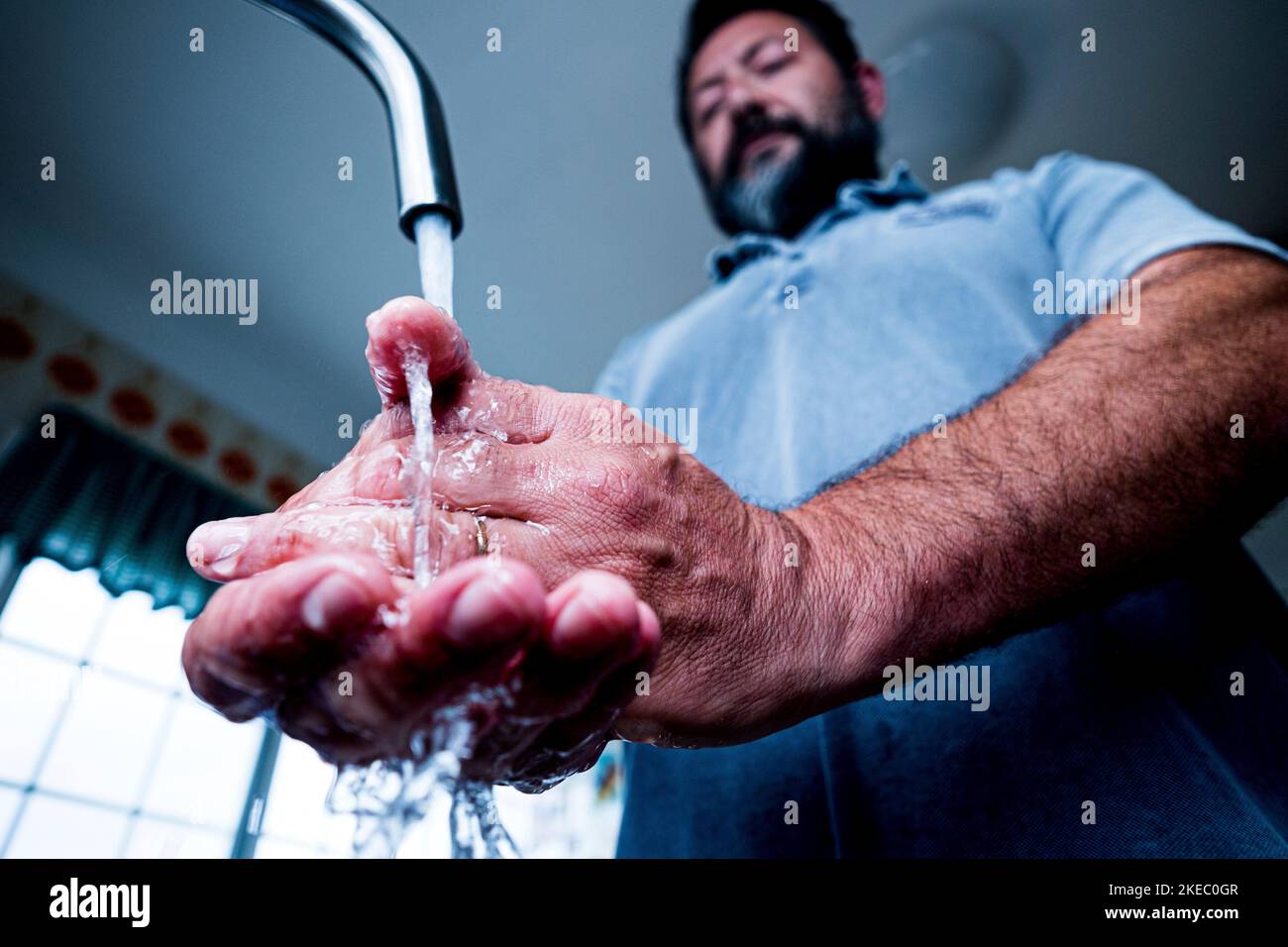 close up and portrait of hands of man cleaning and washing his hands at ...
