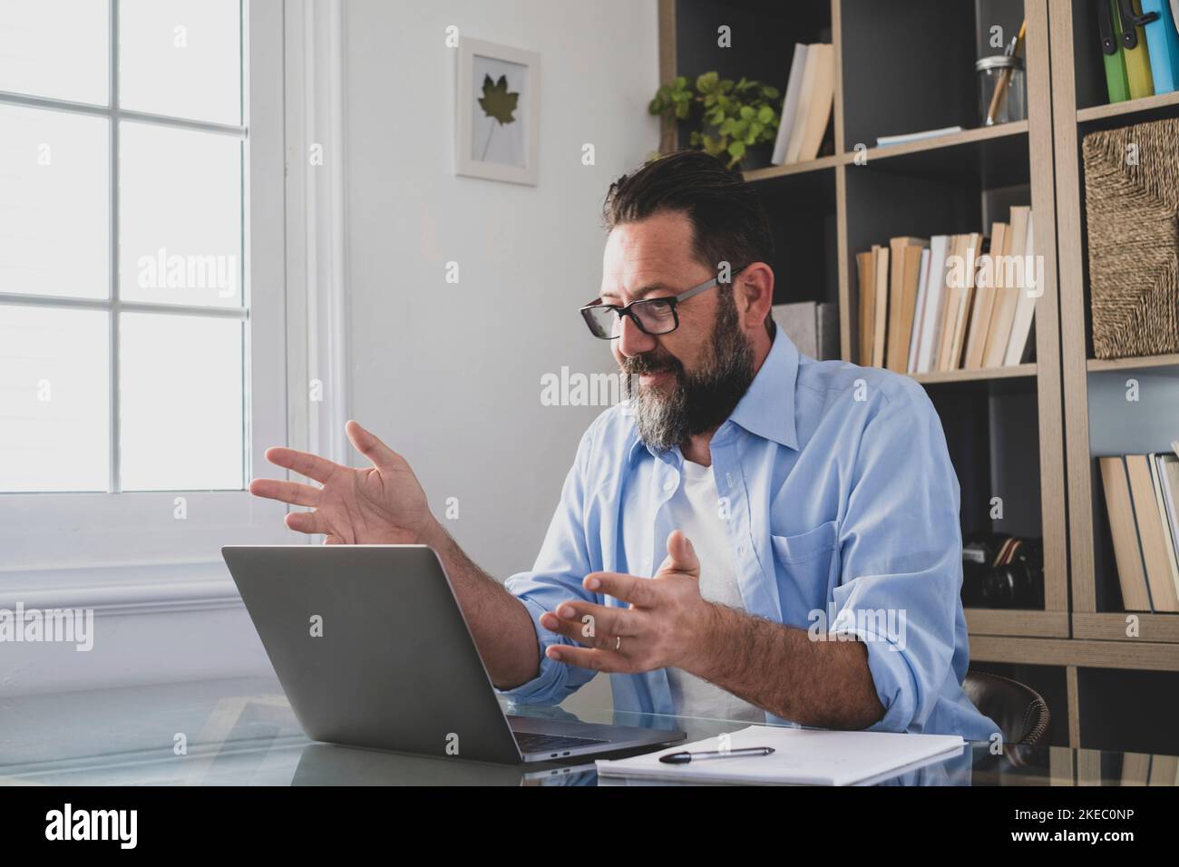 One happy and old entrepeneur man working doing a video conference ...