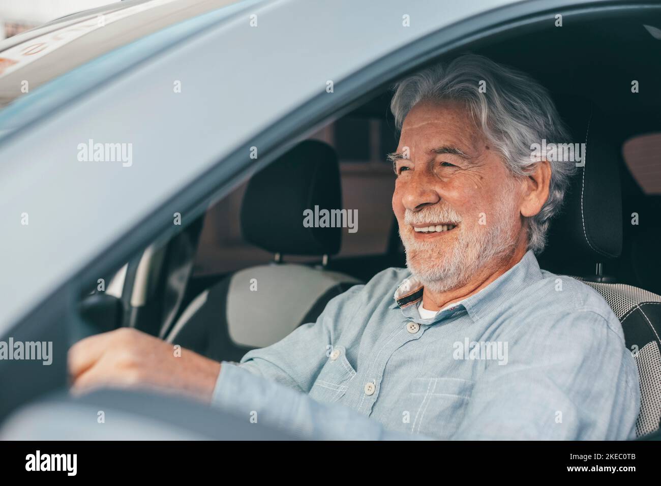 Happy owner. Handsome bearded mature man sitting relaxed in his newly ...