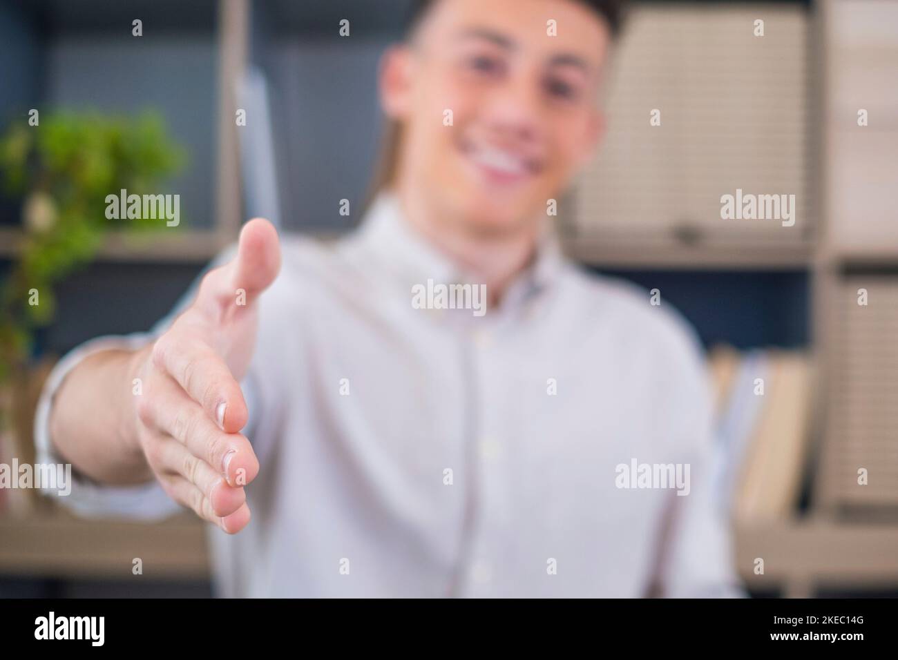 Head shot portrait smiling businessman wearing glasses extending hand ...