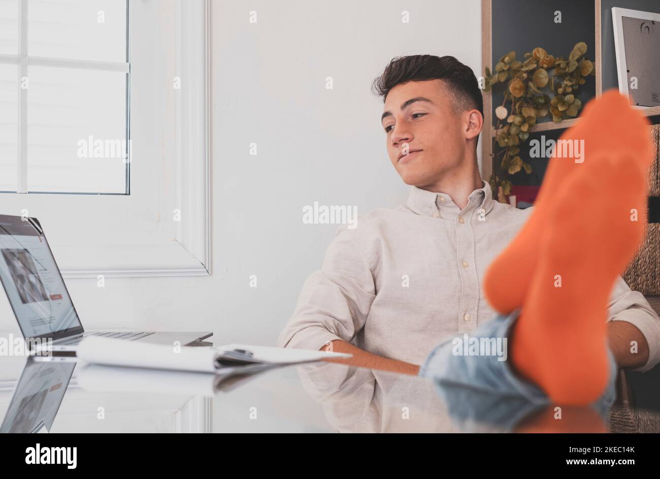 Satisfied teenager happy to finish work with laptop at home, raises ...