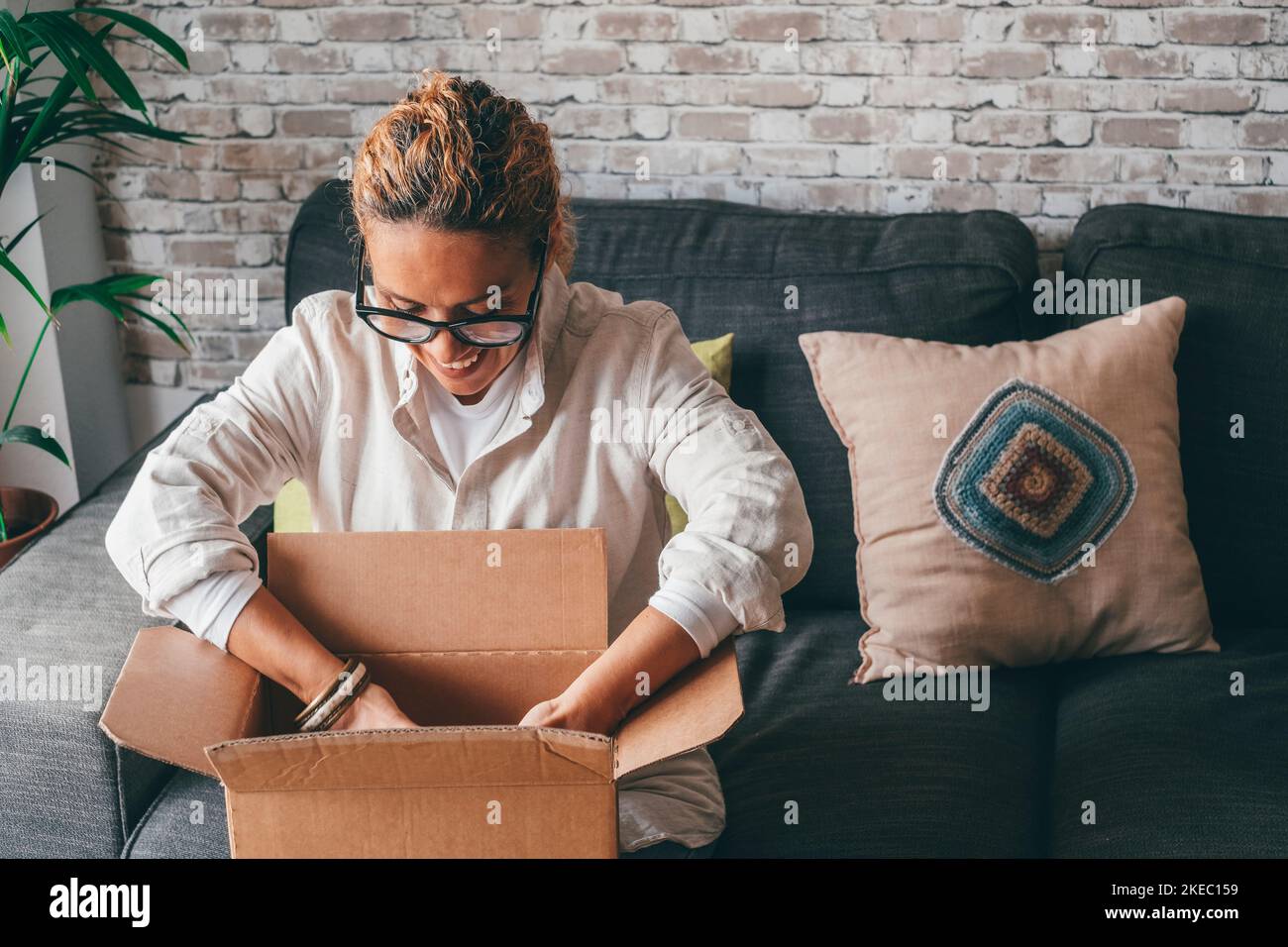 Woman unpacking delivered carton box hi-res stock photography and ...