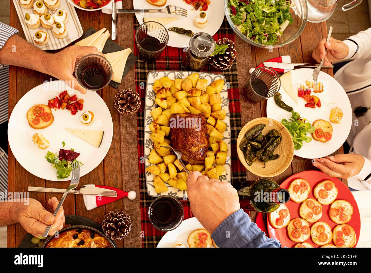 top and above view on a big wooden table full of food like chicken and ...