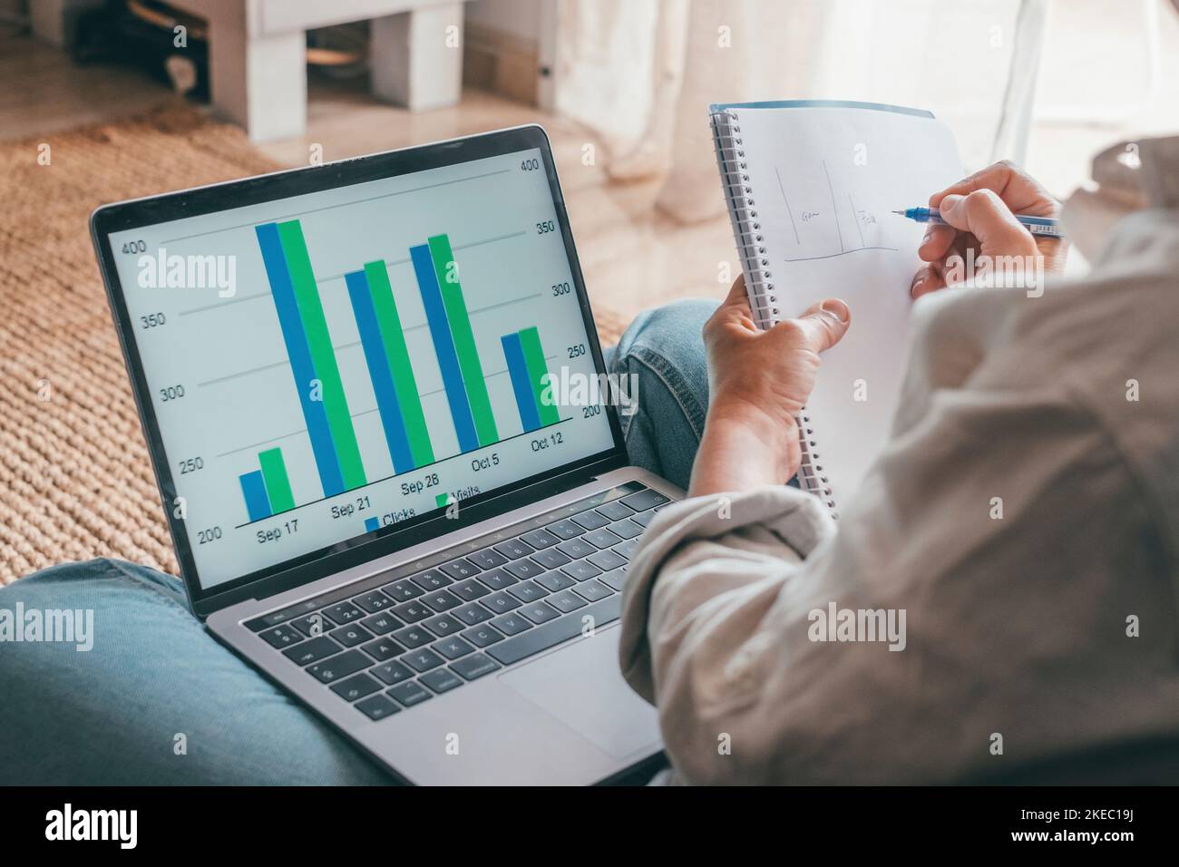 Close up rear view young woman using laptop and calculator, working on ...