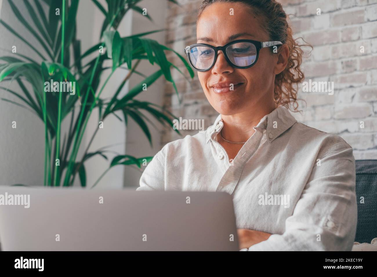 Close up rear view young woman using laptop and calculator, working on ...