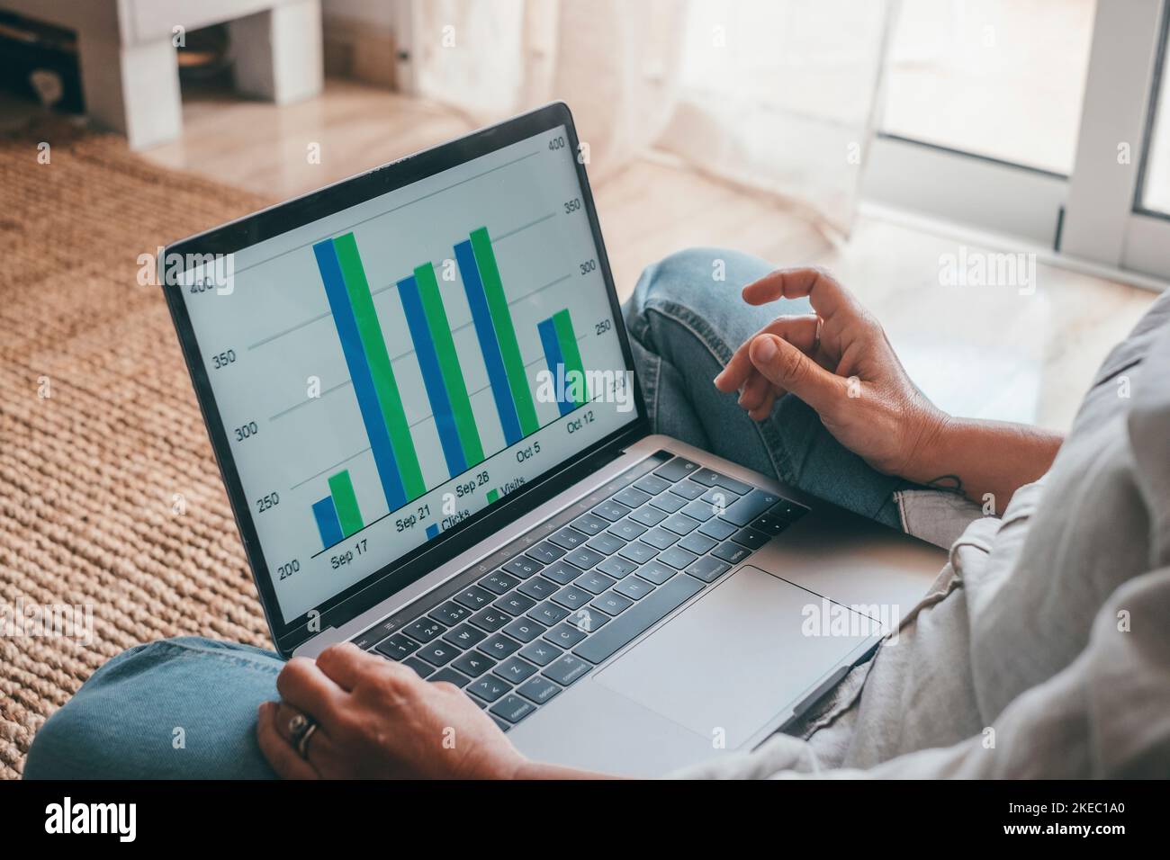 Close up rear view young woman using laptop and calculator, working on ...