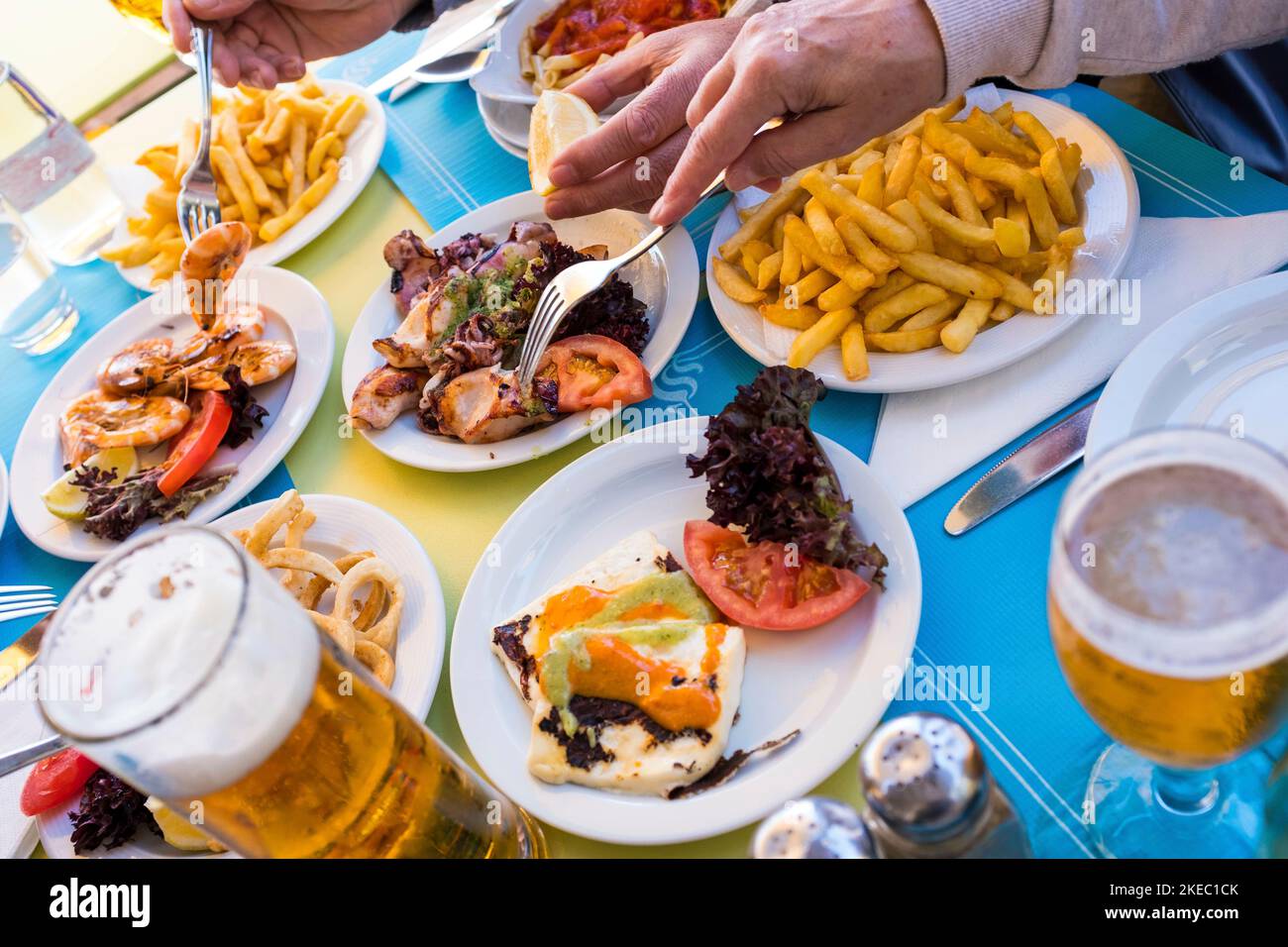 table with marine food like fish - close up and portrait of hands ...