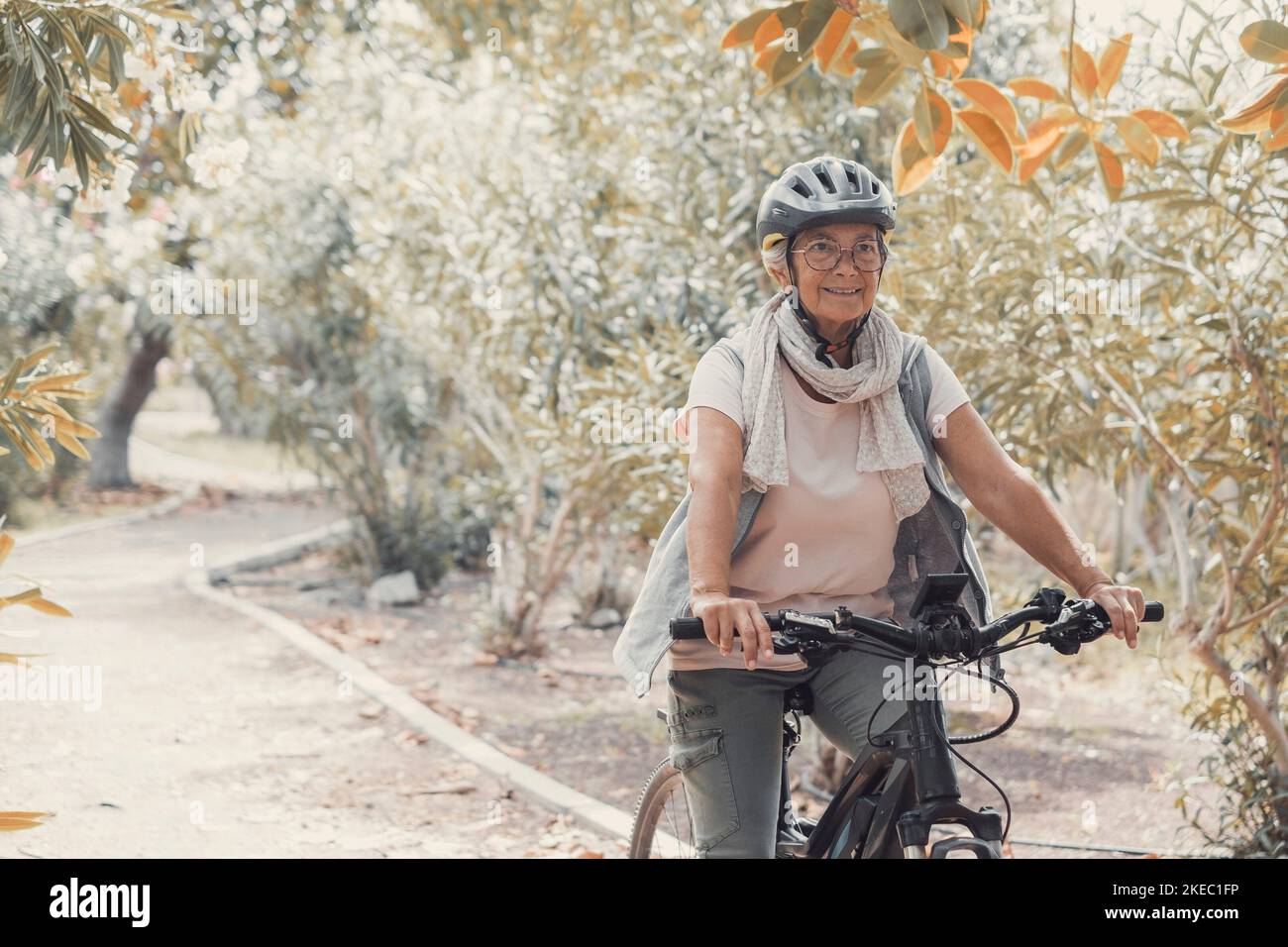Elderly woman biking with helmet hi-res stock photography and images ...