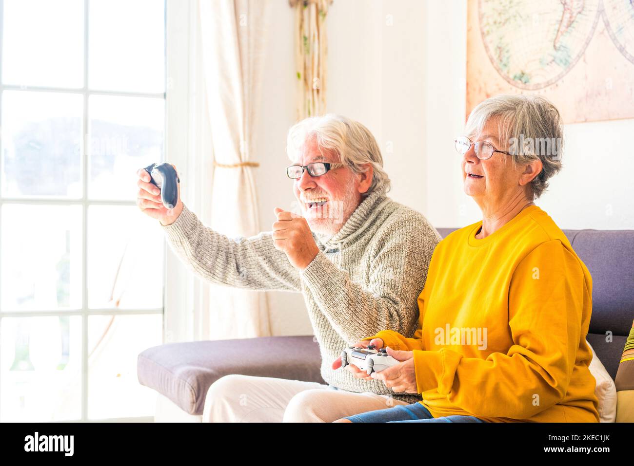 couple of seniors and mature people looking and the tv and using ...