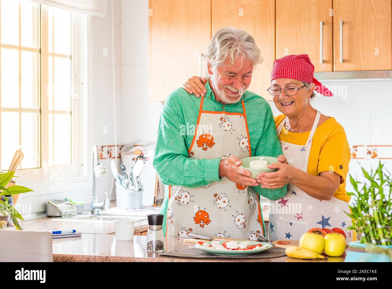 couple of two happy seniors having fun and cooking together in the ...