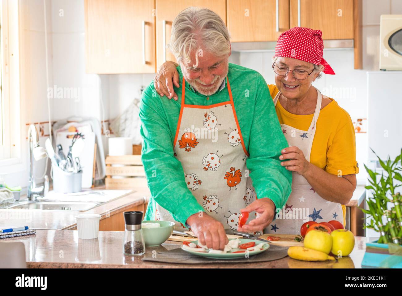 couple of two happy seniors having fun and cooking together in the ...