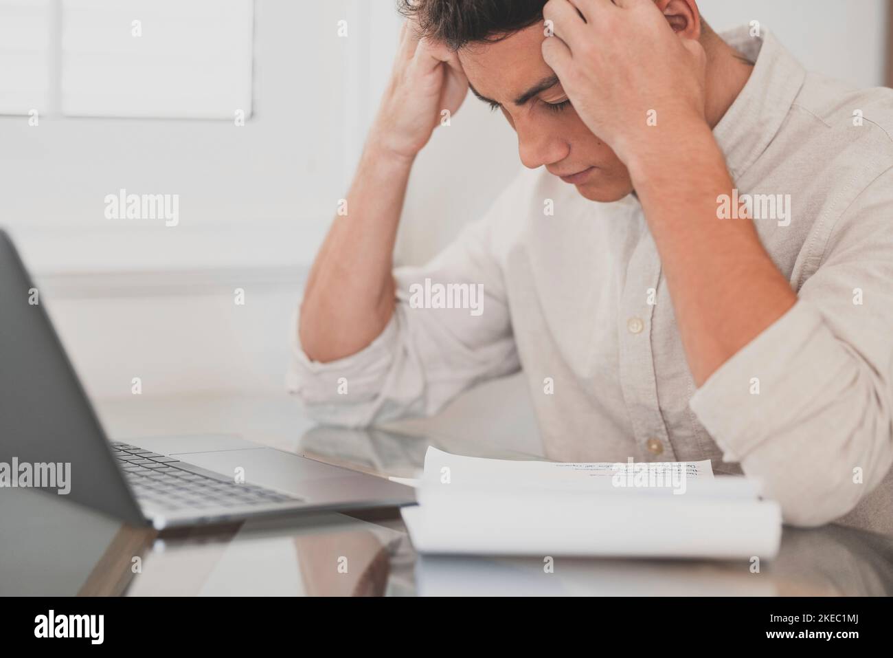 Unhealthy stressed young man suffering headache at home because ...