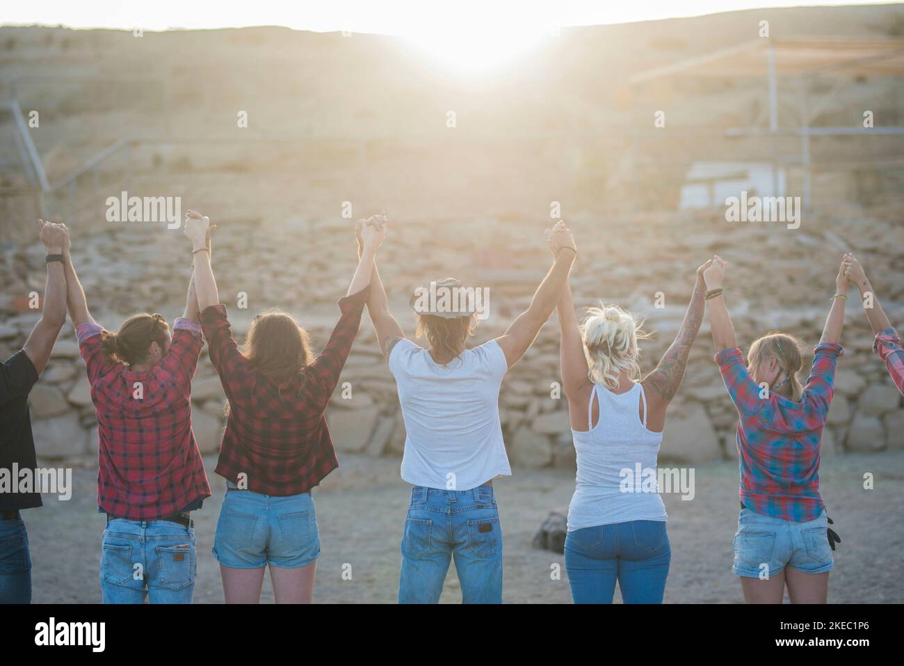 group of seven people holding their hands between and looking at the ...