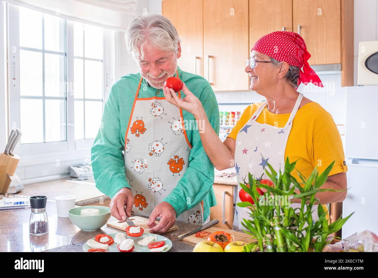 couple of two happy seniors having fun and cooking together in the ...