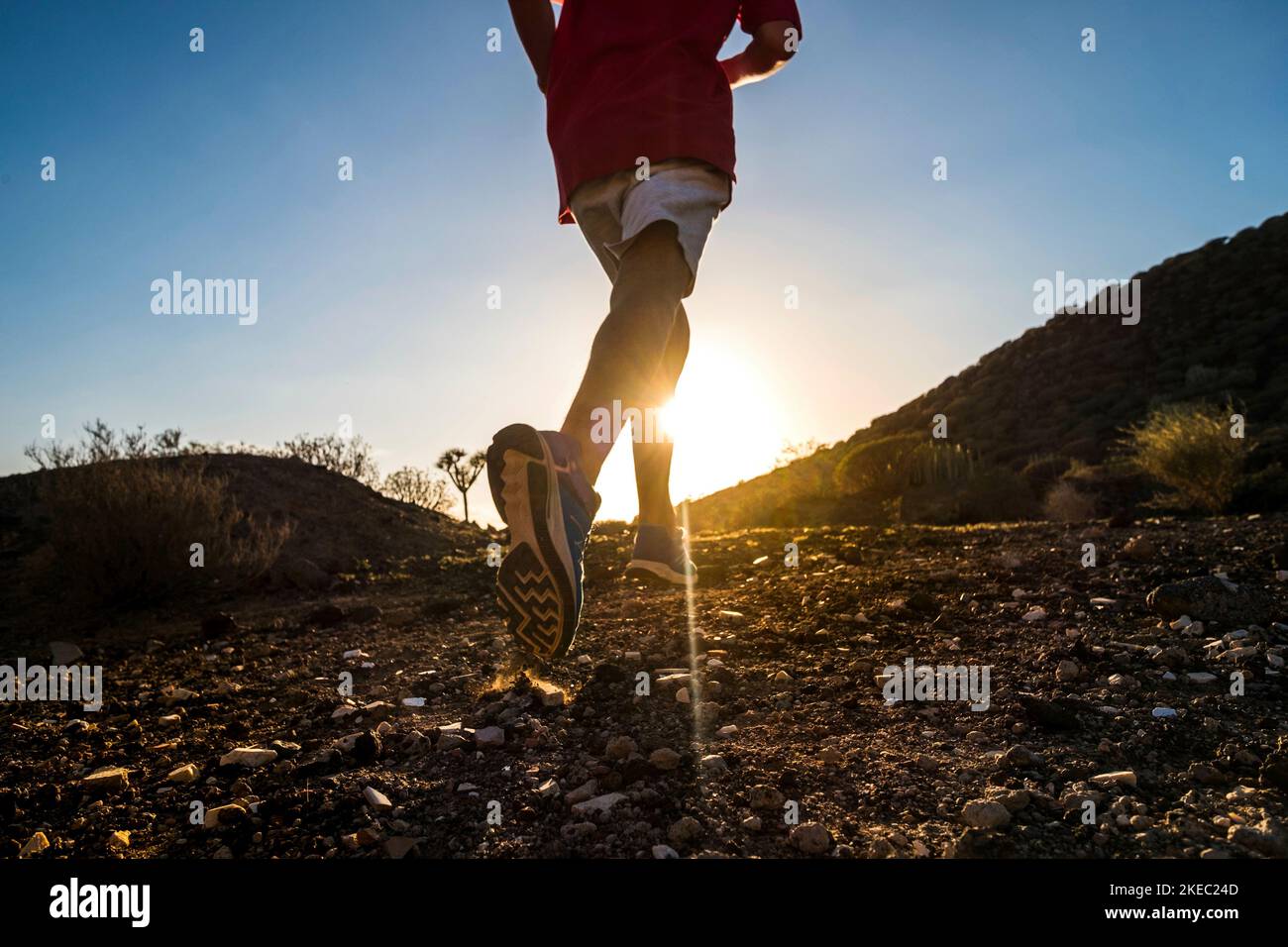 one man running alone inn the hills at the sunset - healtyh and fitness ...