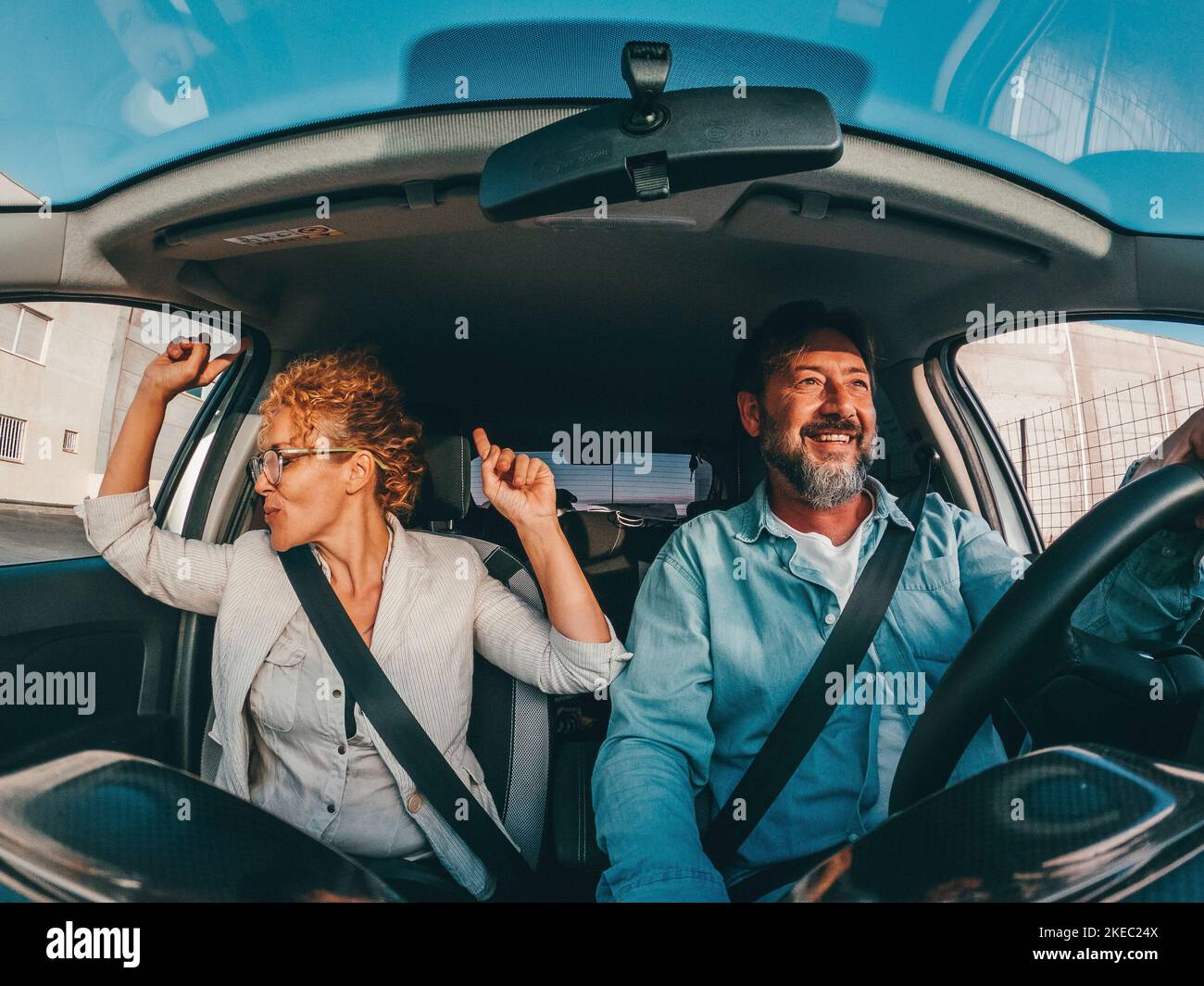 Couple Of Happy People Dancing And Singing In The Car Driving And