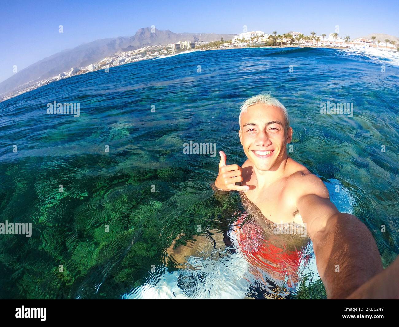 one teenager man enjoying surfing lifestyle at the beach in the sea or ...