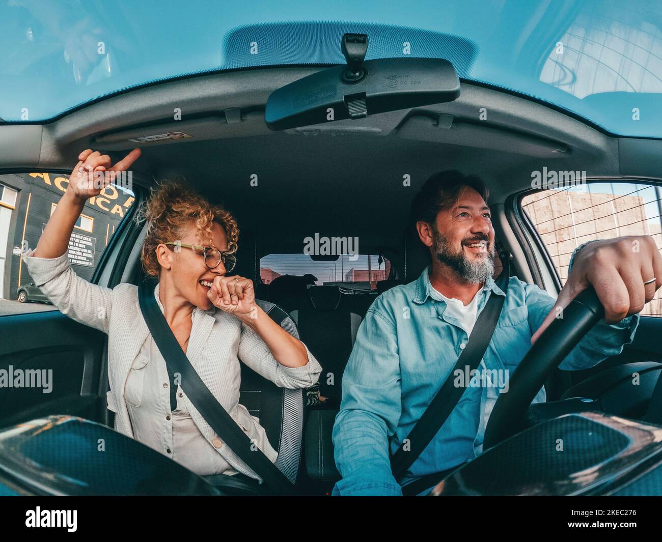 Couple Of Happy People Dancing And Singing In The Car Driving And