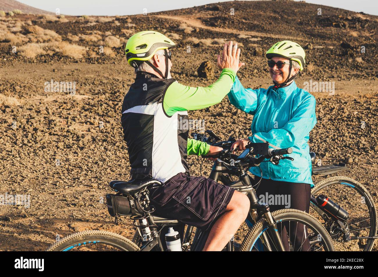 couple of two caucasian seniors bumped and giving five together ...