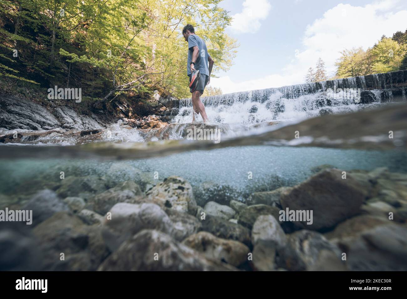 Man crossing river Stock Photo - Alamy