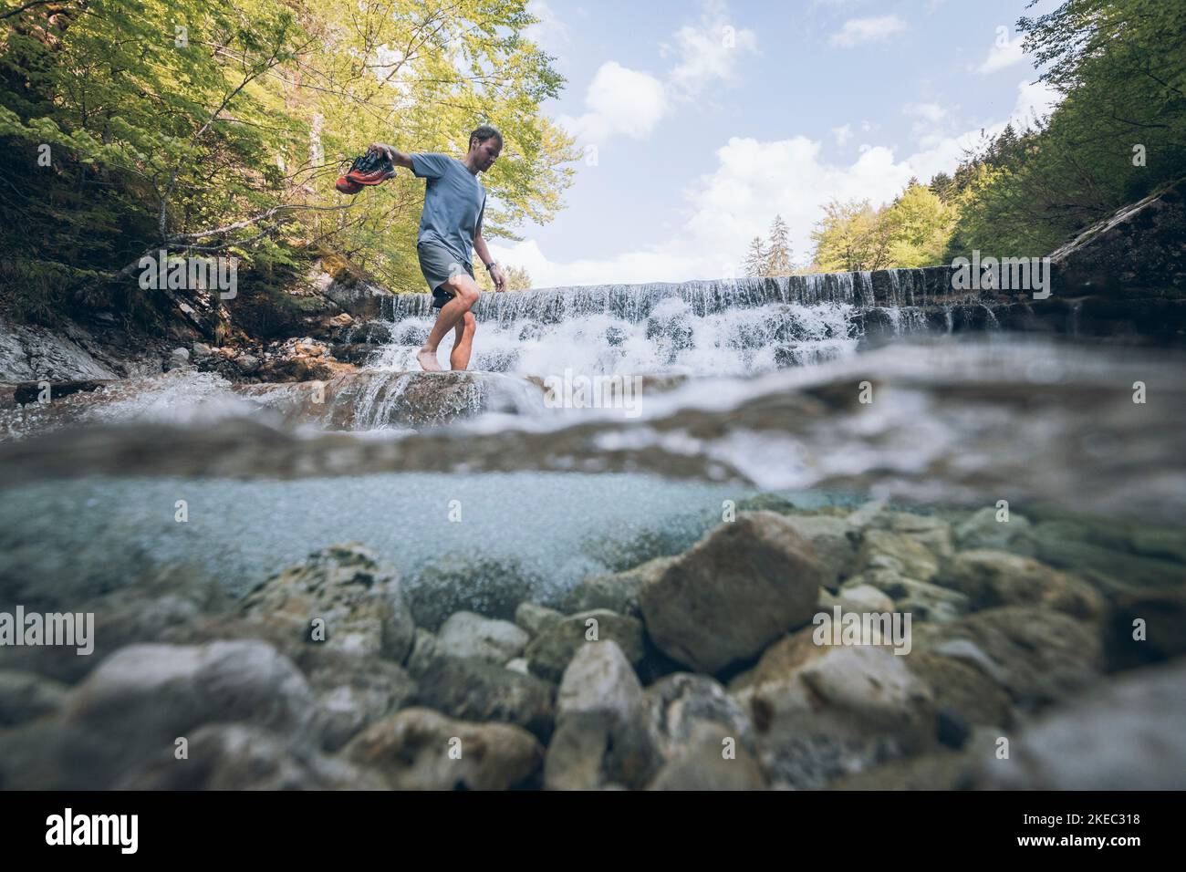 Man crossing river Stock Photo - Alamy