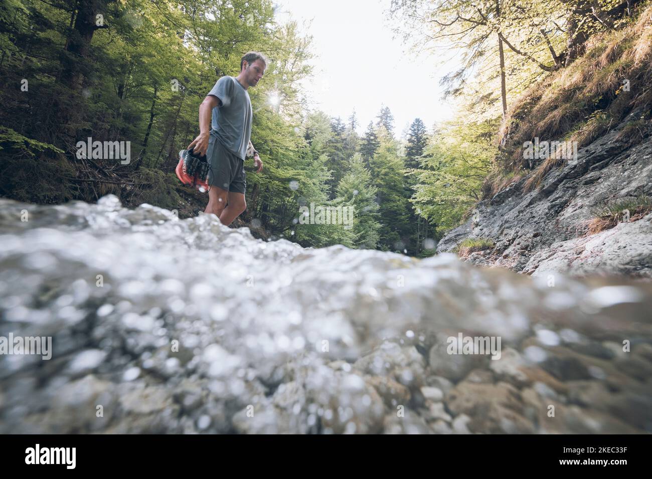 Man crossing river Stock Photo - Alamy