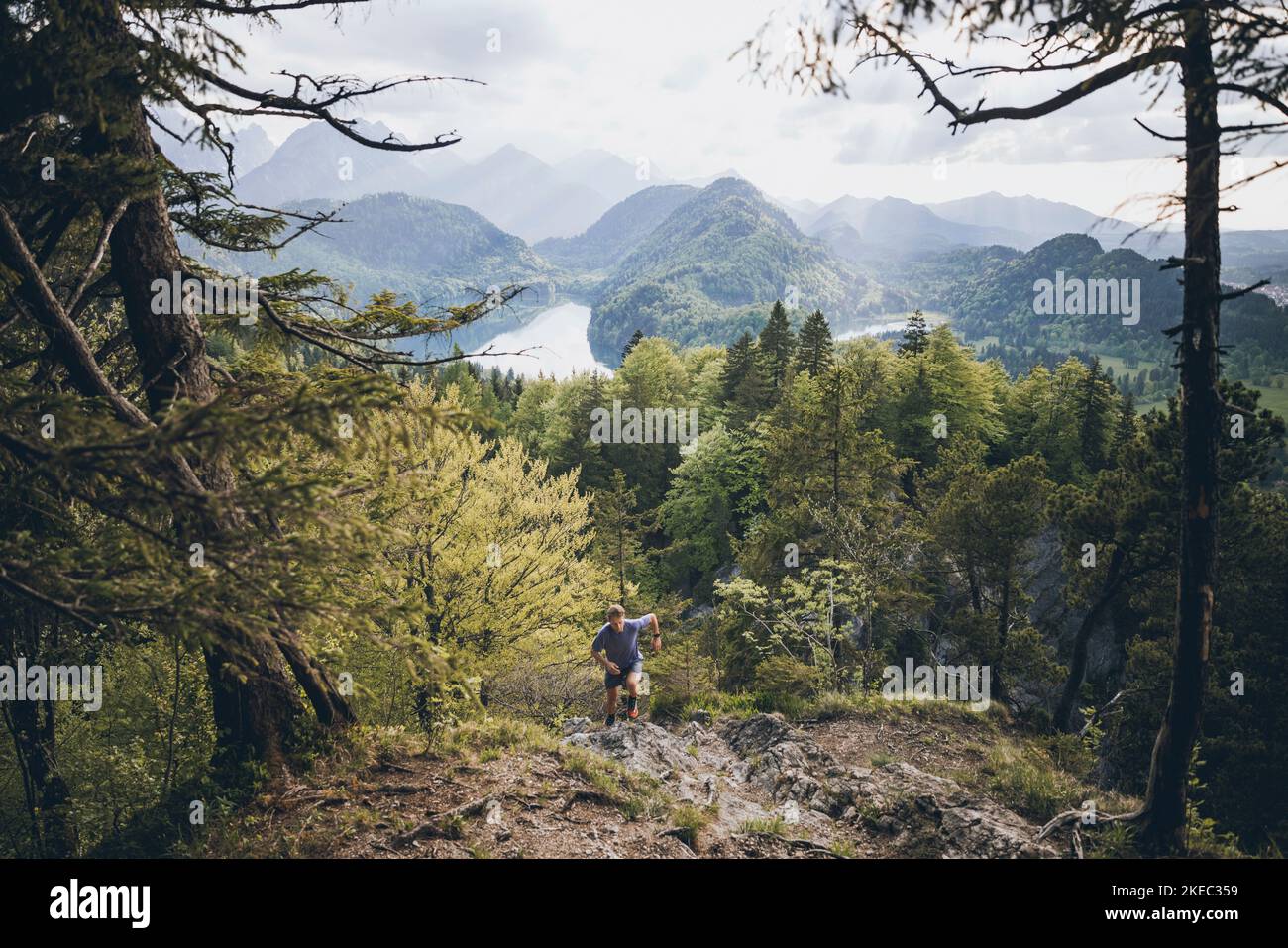 Man running, in the background alpine panorama with mountain lake Stock ...