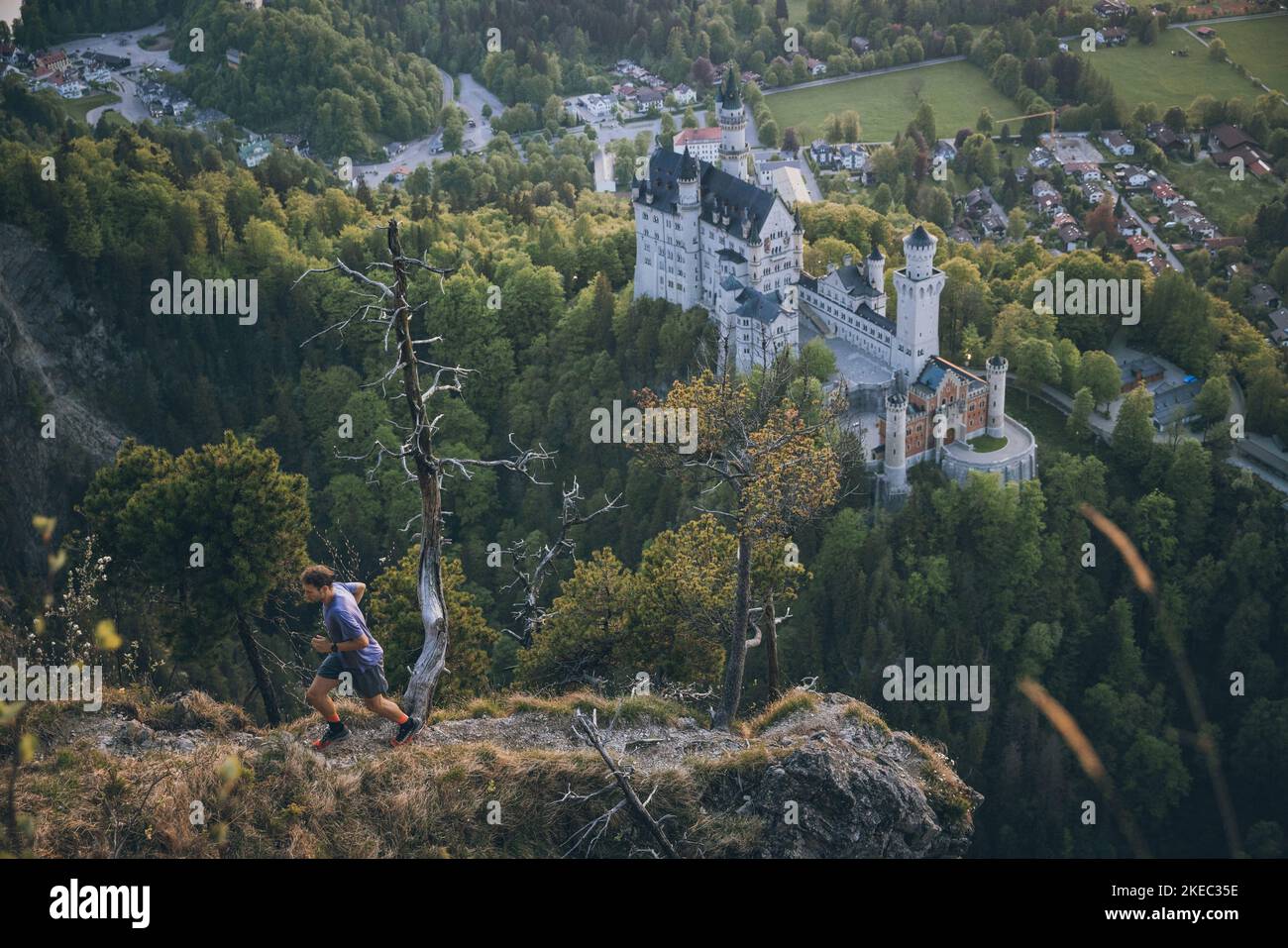 Man running above Neuschwanstein castle Stock Photo - Alamy