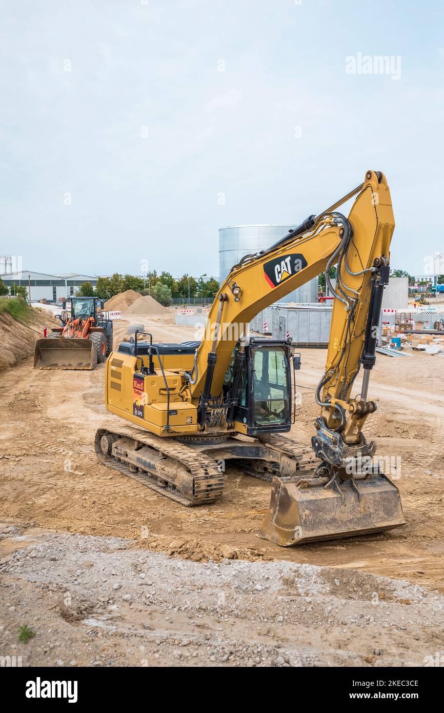 Construction site with excavator in summer Stock Photo - Alamy