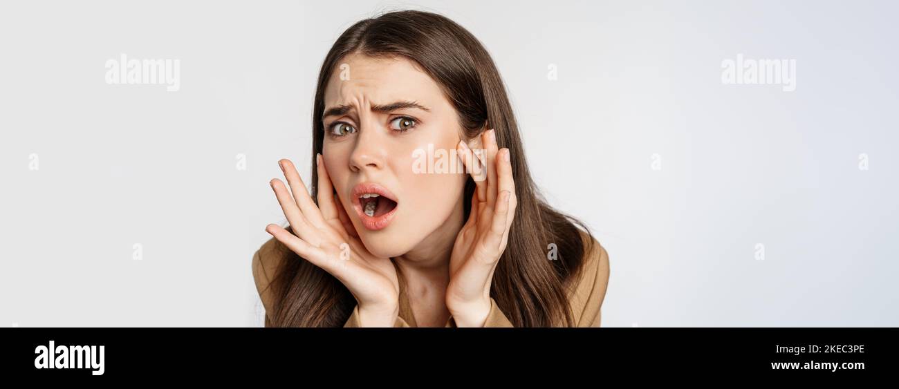 Image of sad girl looking in mirror and touching facial skin, shocked ...