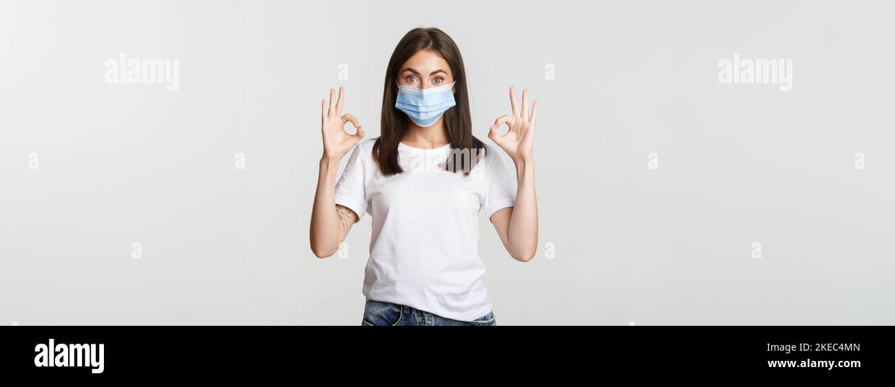 Covid-19, health and social distancing concept. Excited smiling pretty ...