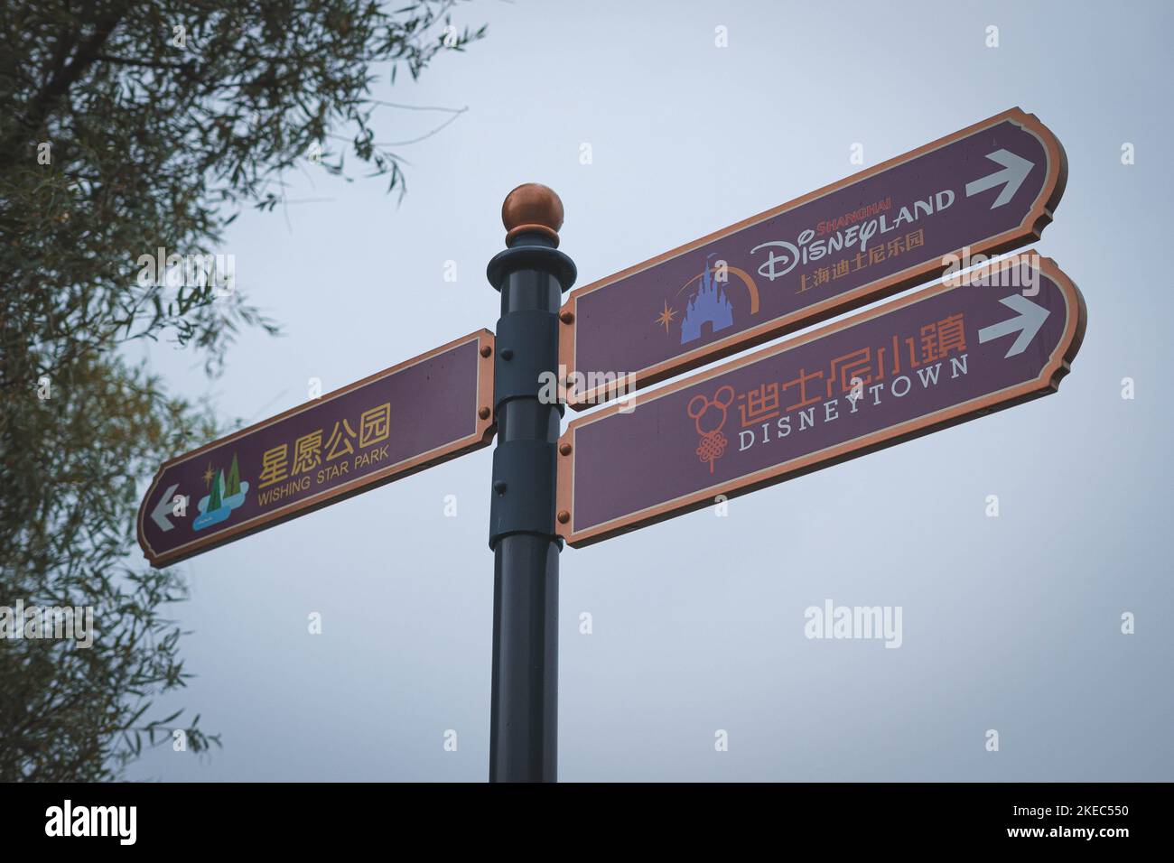 A closeup of Shanghai Downtown Disneyland Direction Sign against the ...
