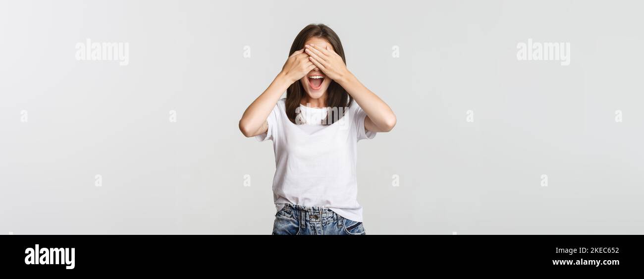 Cheerful smiling woman shut eyes and expect surprise Stock Photo - Alamy