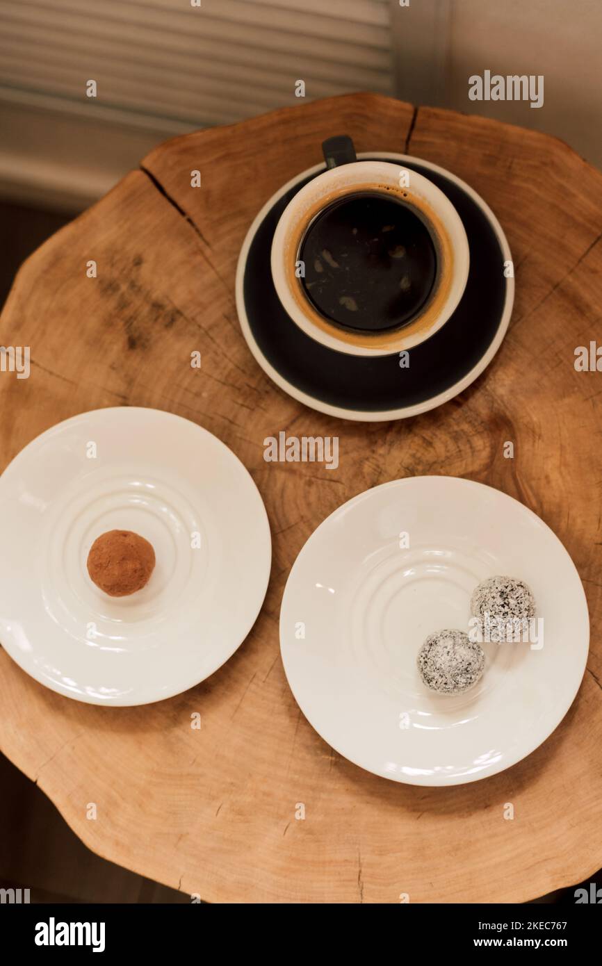 Wooden round table with coffee and desserts. Coffee break Stock Photo ...